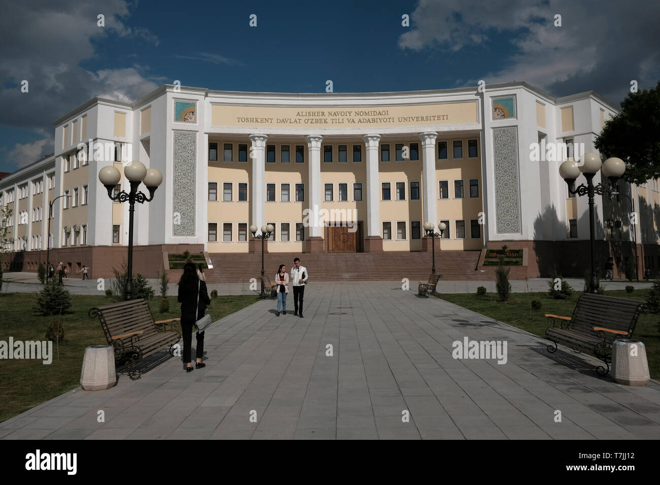 Pedestrians walking in front of the Tashkent State University of Uzbek ...