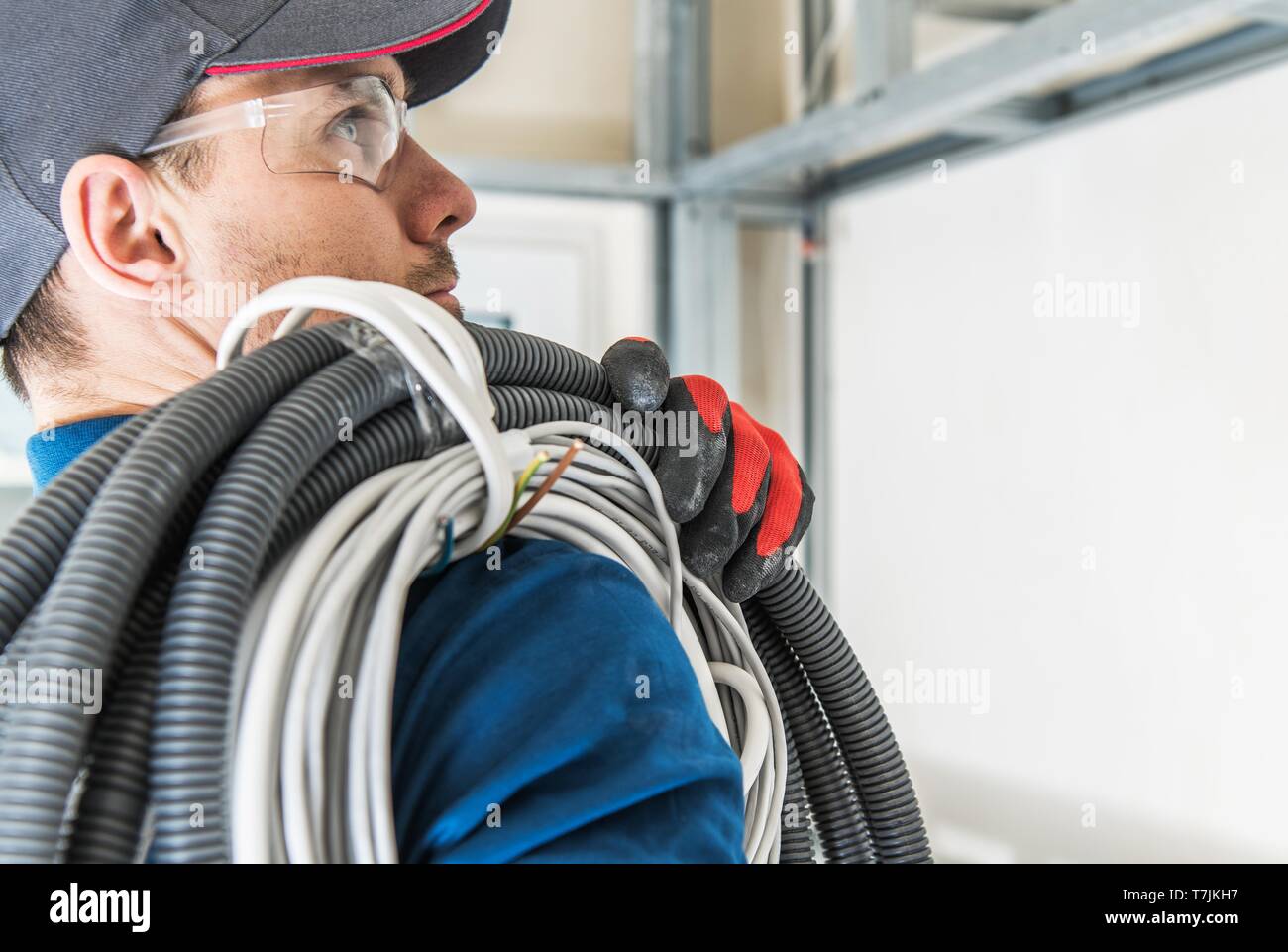 Caucasian Contractor Electrician with Cables and Pipes on His Shoulder ...