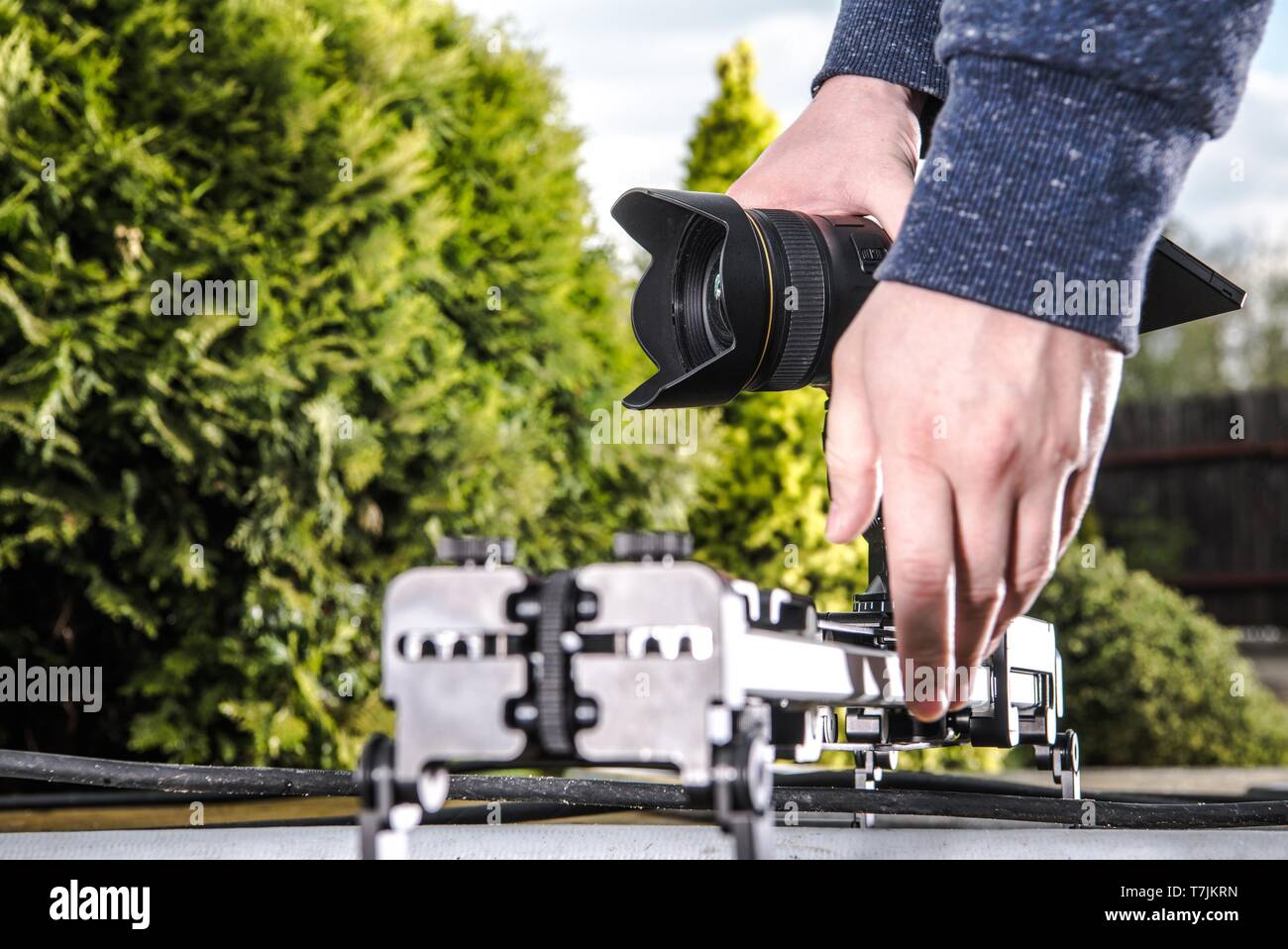 Videographer with DSLR Slider Preparing For Steady Shot with Smooth ...