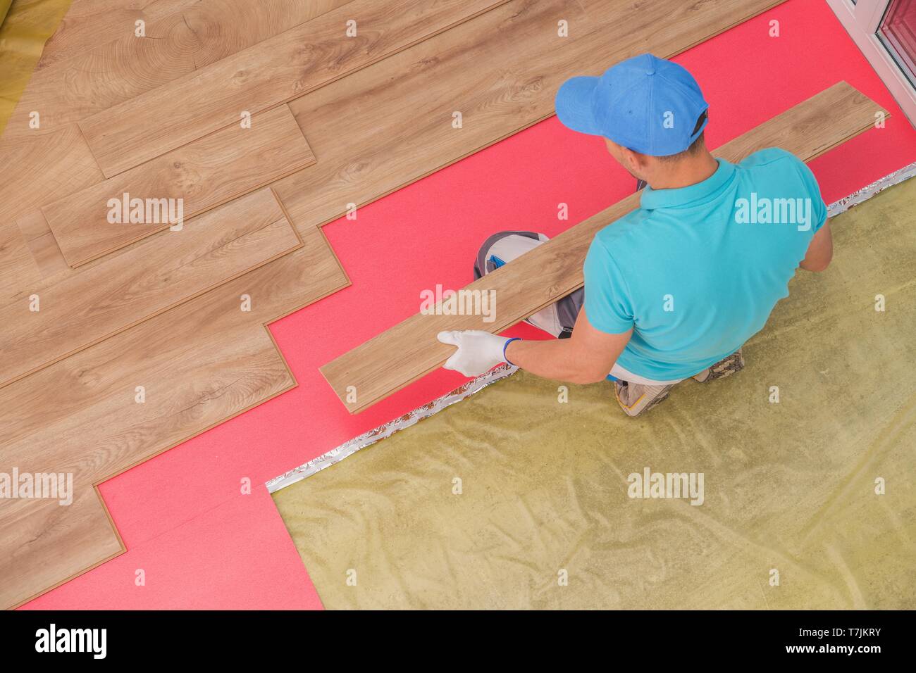 Wooden Floor Panels Installer. Caucasian Remodeling Worker in His 30s ...
