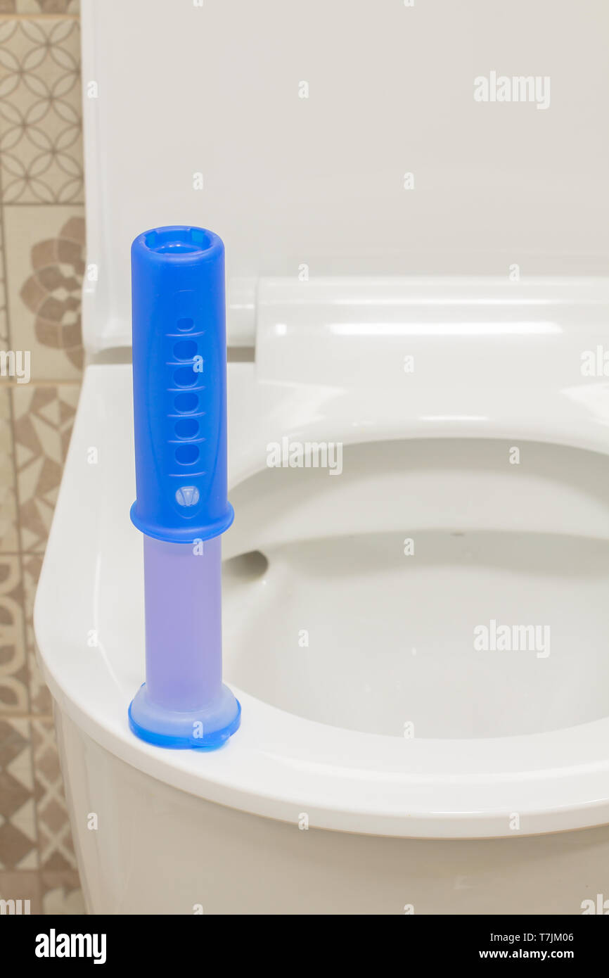 Modern toilet bowl with blue detergent for cleaning and disinfection ...