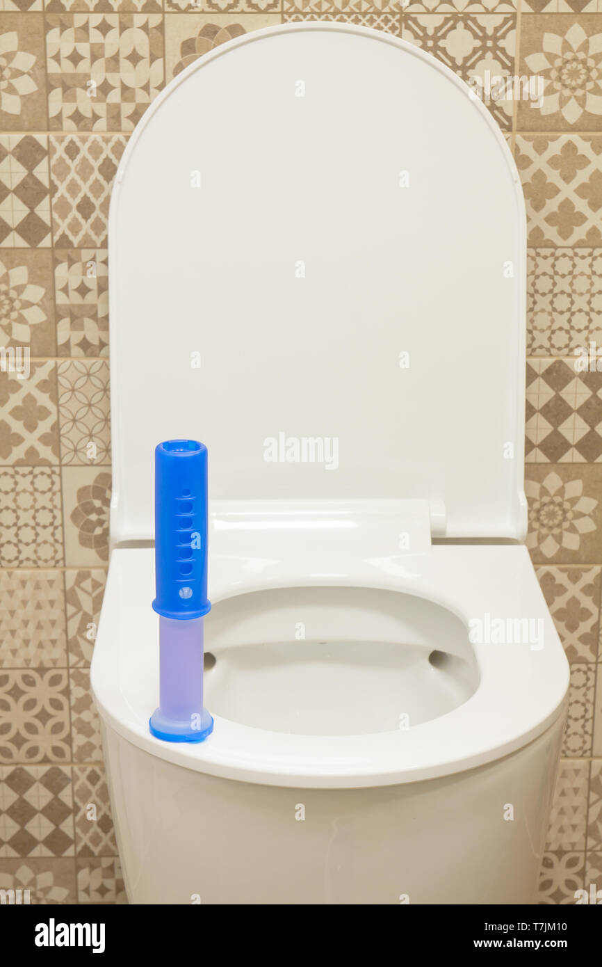 Modern toilet bowl with blue detergent for cleaning and disinfection ...