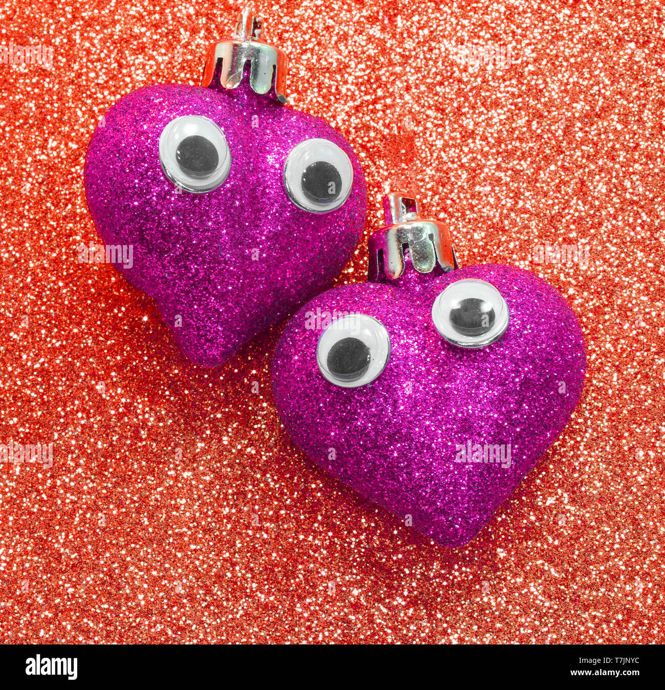 two violet hearts in love with eyes on the glitter background Stock ...