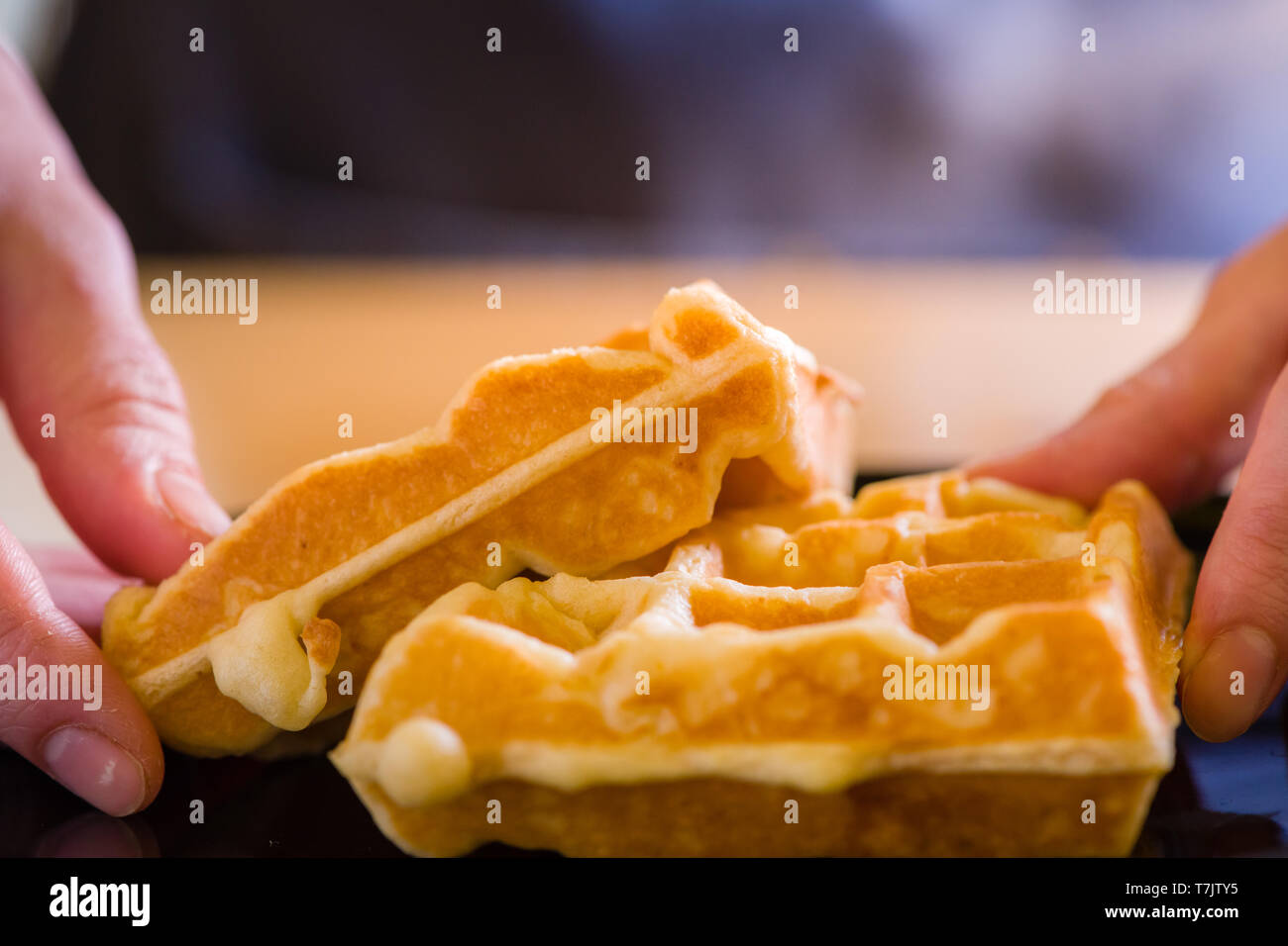 woman hands prepare waffle for serving process.waffle made from dough ...
