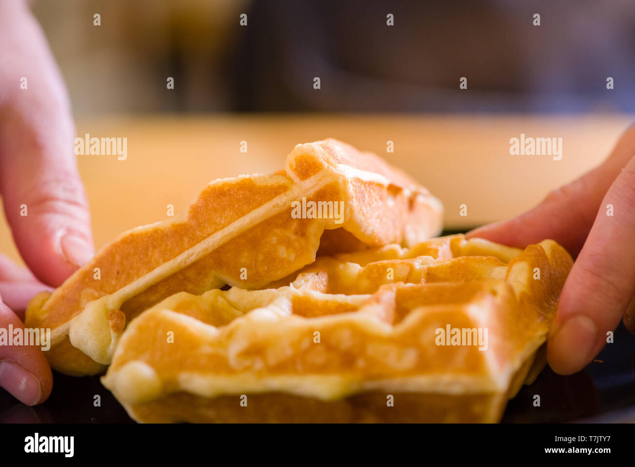 woman hands prepare waffle for serving process.waffle made from dough ...