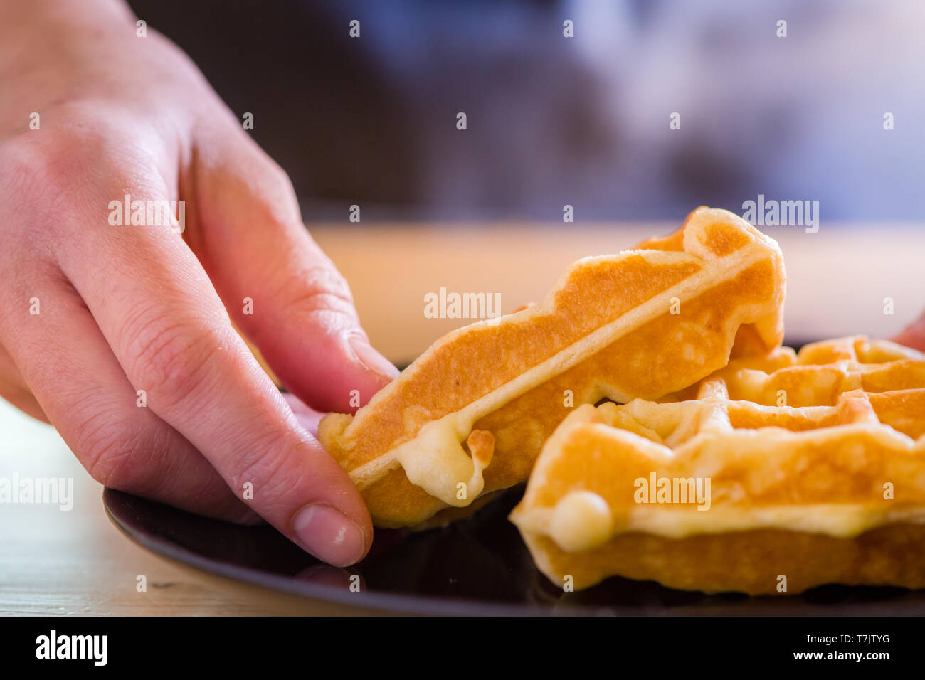 woman hands prepare waffle for serving process.waffle made from dough ...