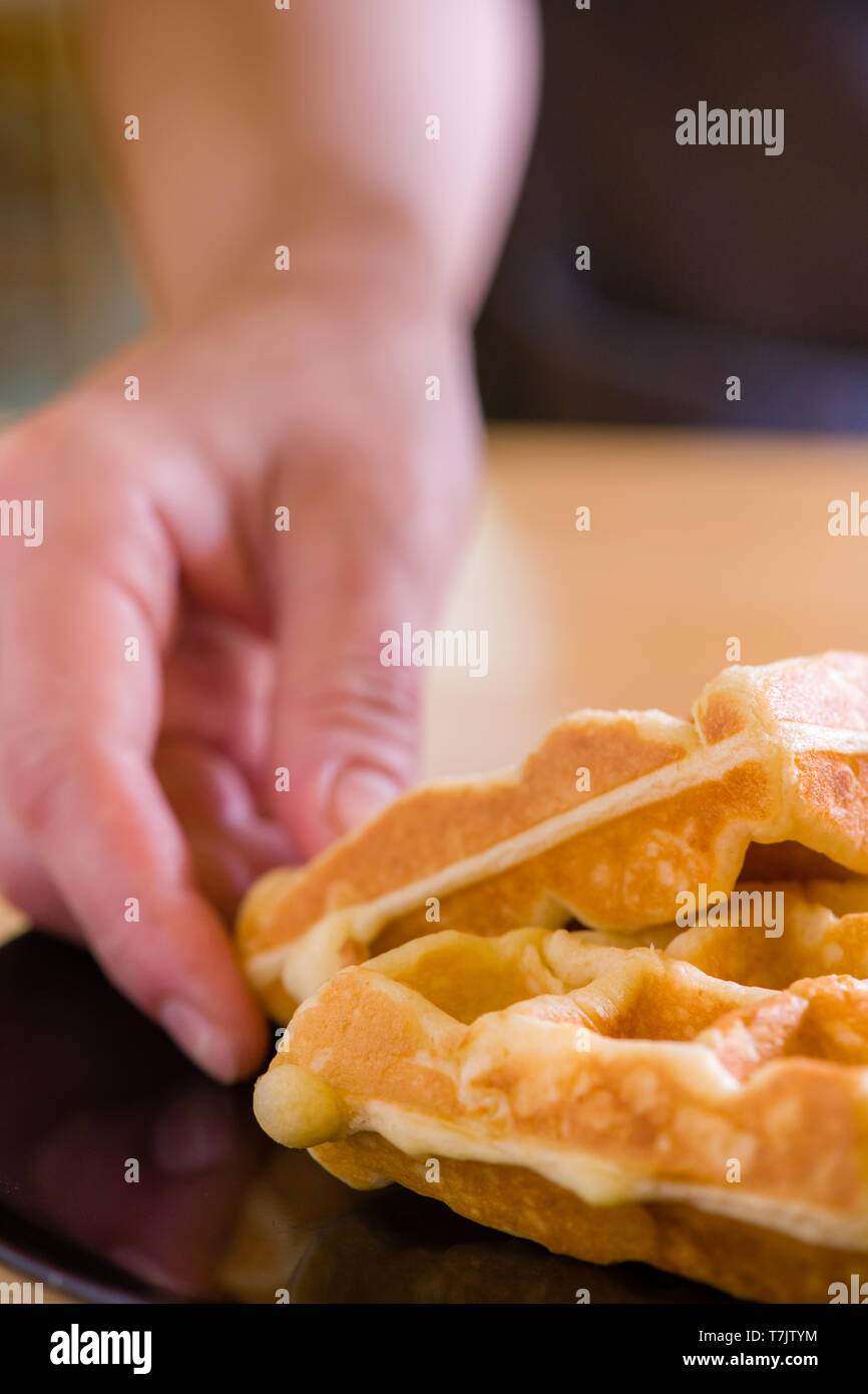 woman hands prepare waffle for serving process.waffle made from dough ...