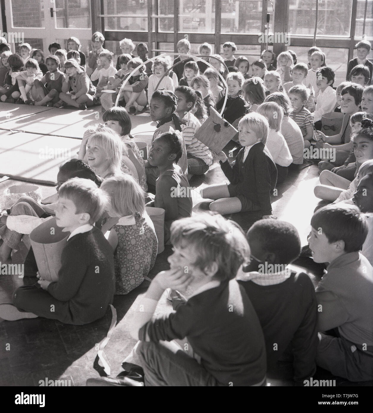 1960s, historical, excited young school children in the school hall ...