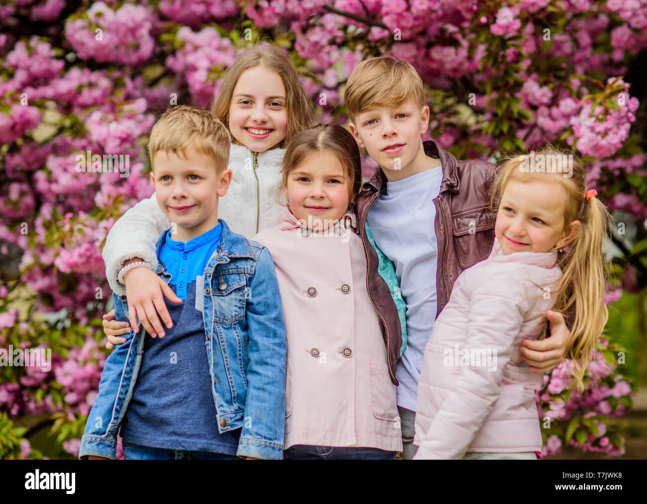 Happy spring vacation. Children enjoy warm spring. Lost in blossom ...