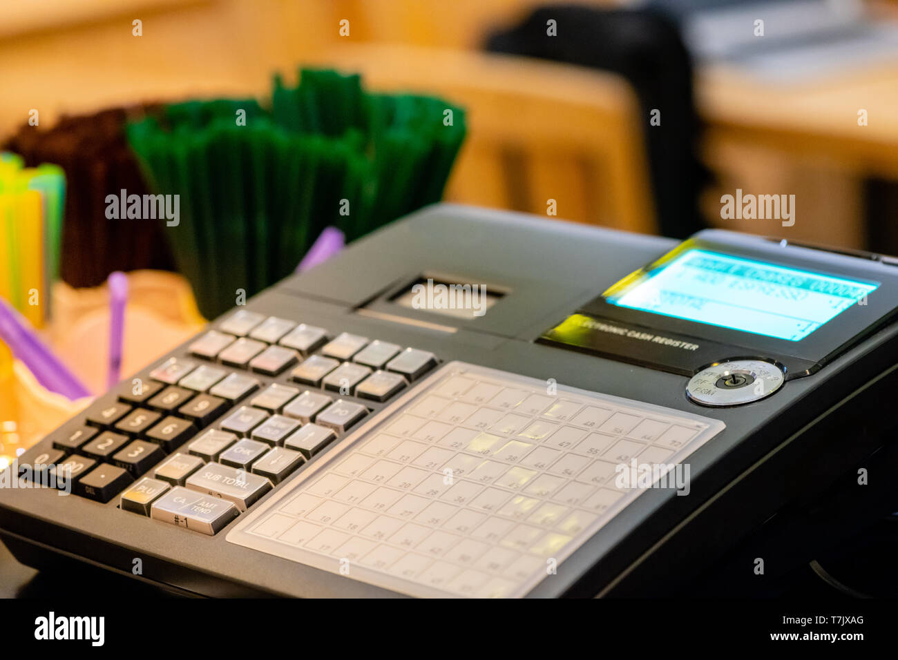 cash register installed on counter for accepting order from customer ...