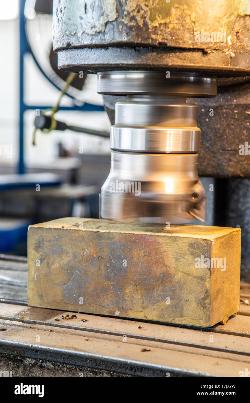 Milling machine tool preparing to process iron detail at industrial ...