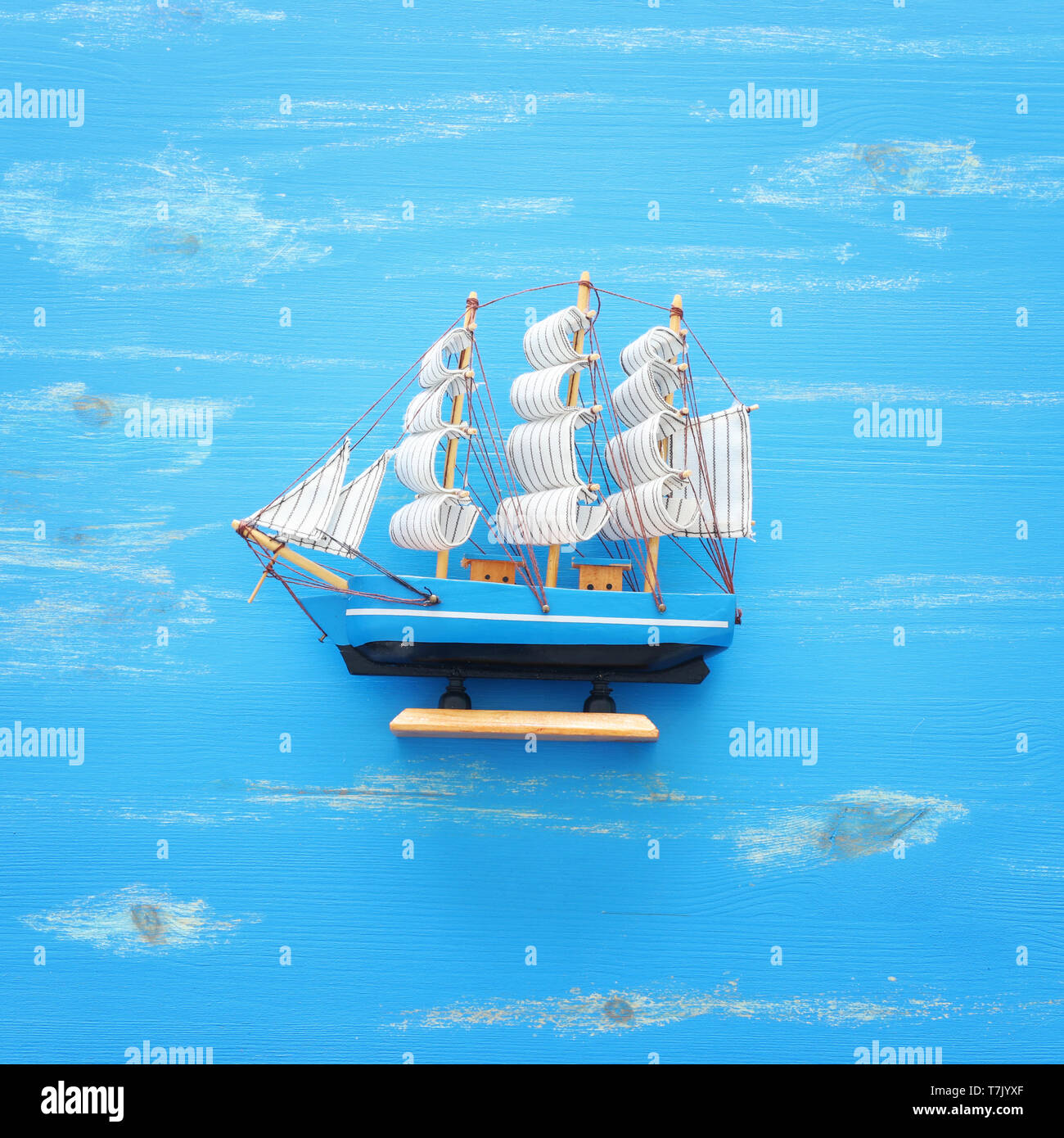 wooden vintage boat over blue background Stock Photo - Alamy