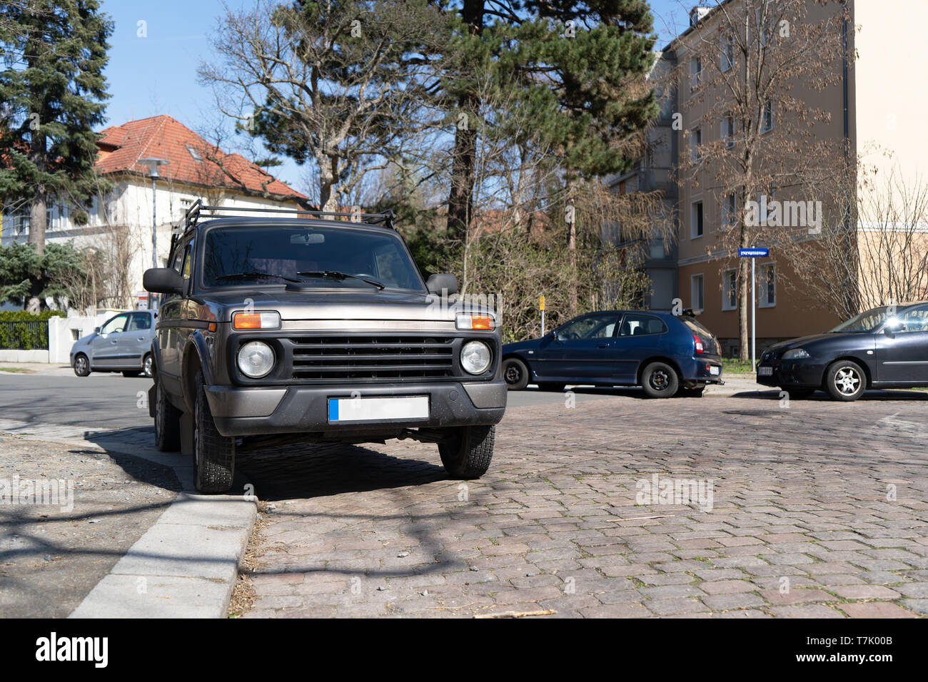 An off-road vehicle is parked on the curb of a German sidewalk. The ...
