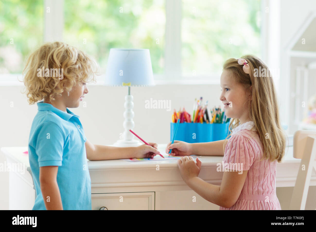 Child drawing rainbow. Kid painting at home. Little girl and boy doing ...