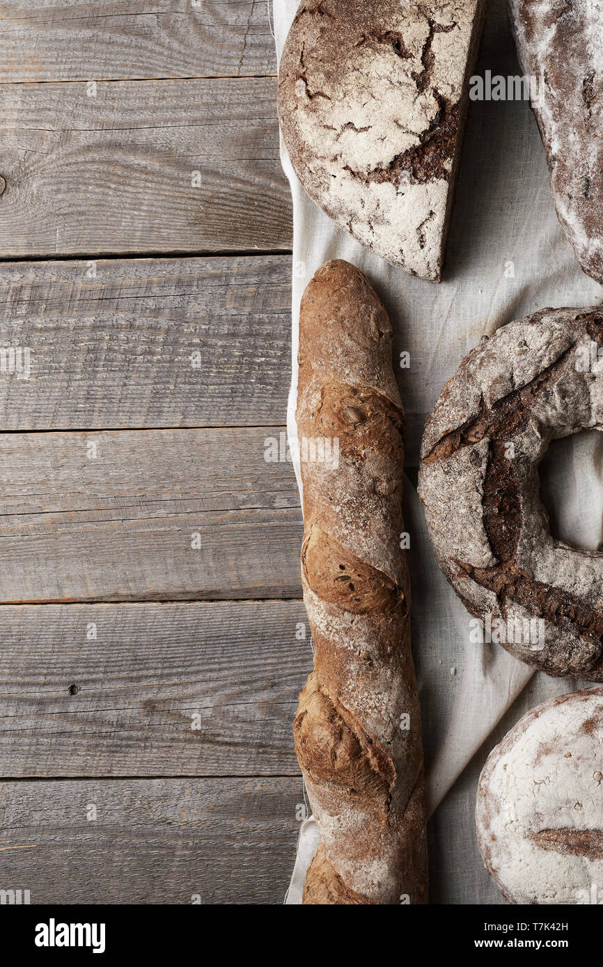 rustic bread loaves top view on wooden background Stock Photo - Alamy