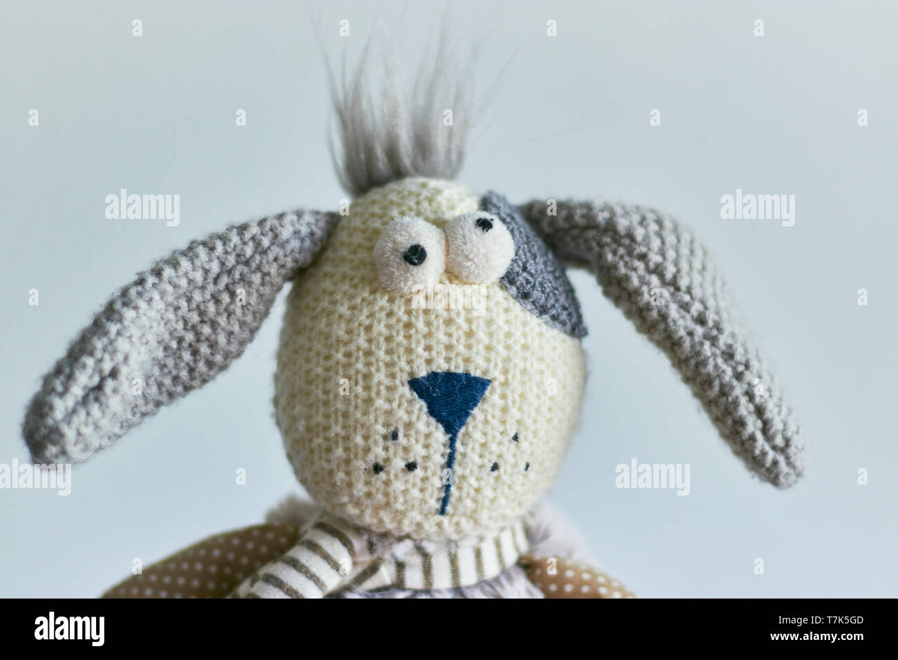 Children's toy plush rabbit isolated on a light background. head of a ...