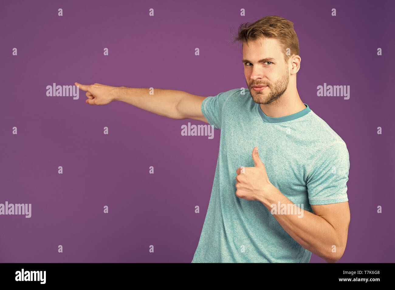 Highly recommend pointing at with index finger. Man unshaven face shows ...