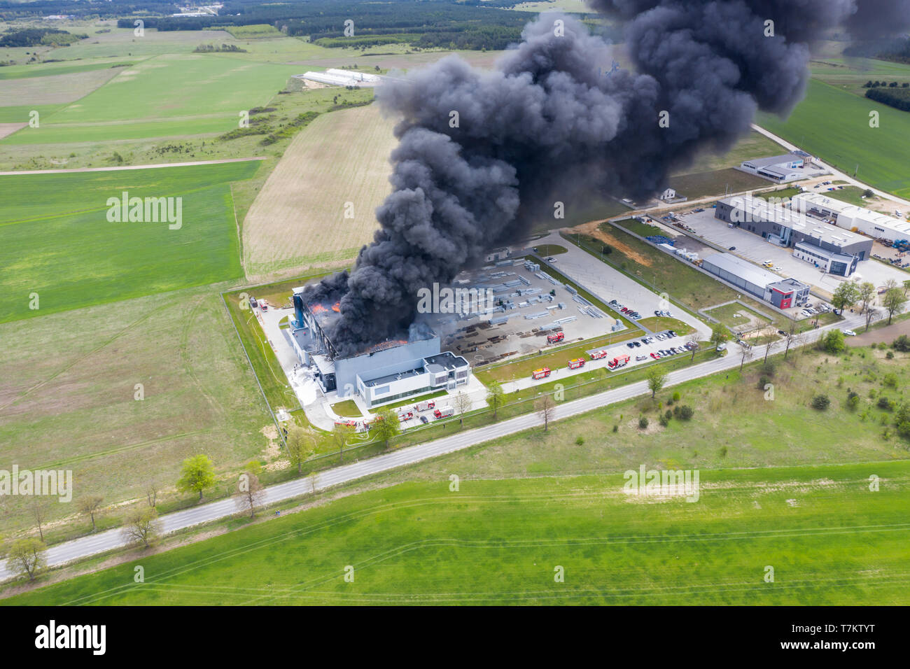 Top down view of smoke clouds from burnt warehouse building with burned ...