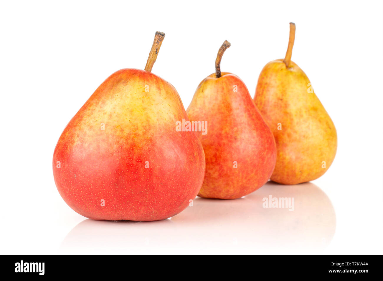 Group of three whole fresh red pear in row isolated on white background ...