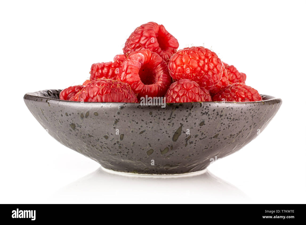 Lot of whole fresh red raspberry on grey ceramic plate isolated on ...