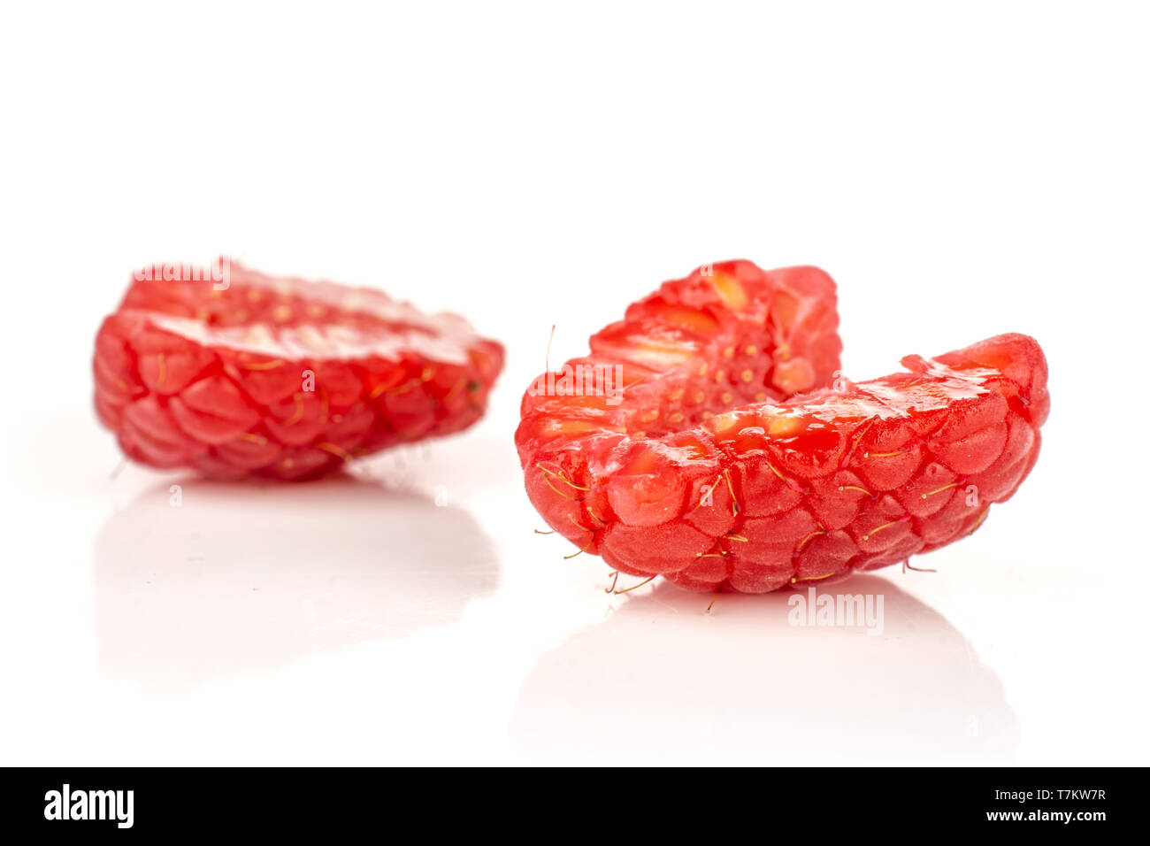 Group of two halves of fresh red raspberry isolated on white background ...