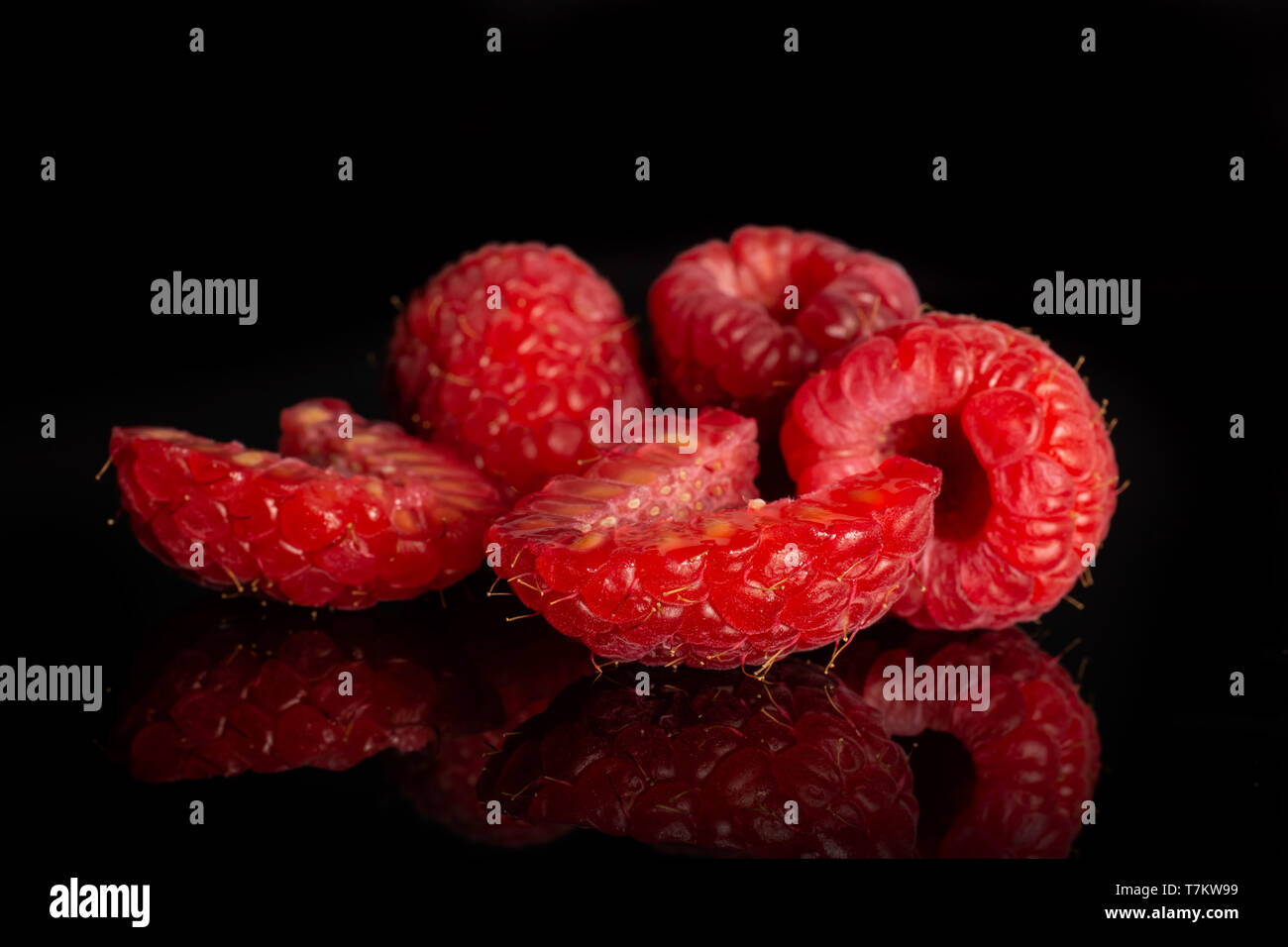 Group of three whole two halves of fresh red raspberry isolated on ...