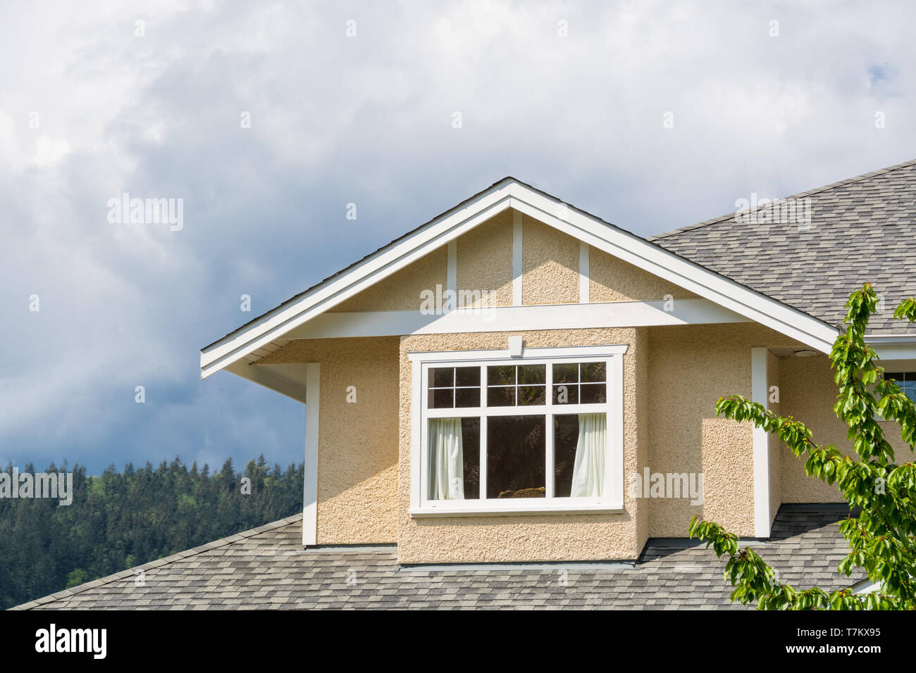 The top of the house with nice windows on cloudy sky background Stock ...