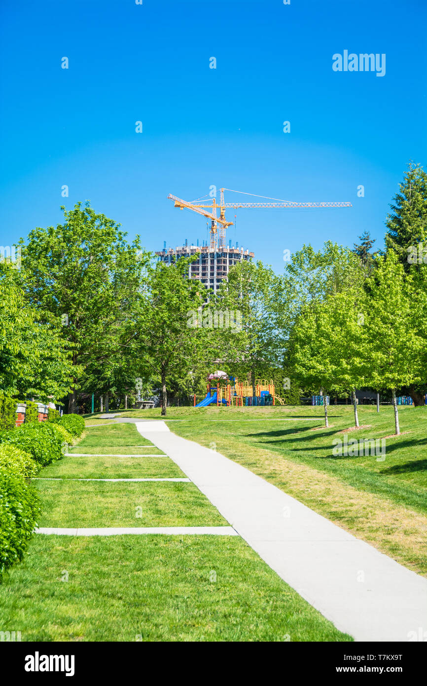 Concrete walkway in park zone leading to the playground Stock Photo - Alamy