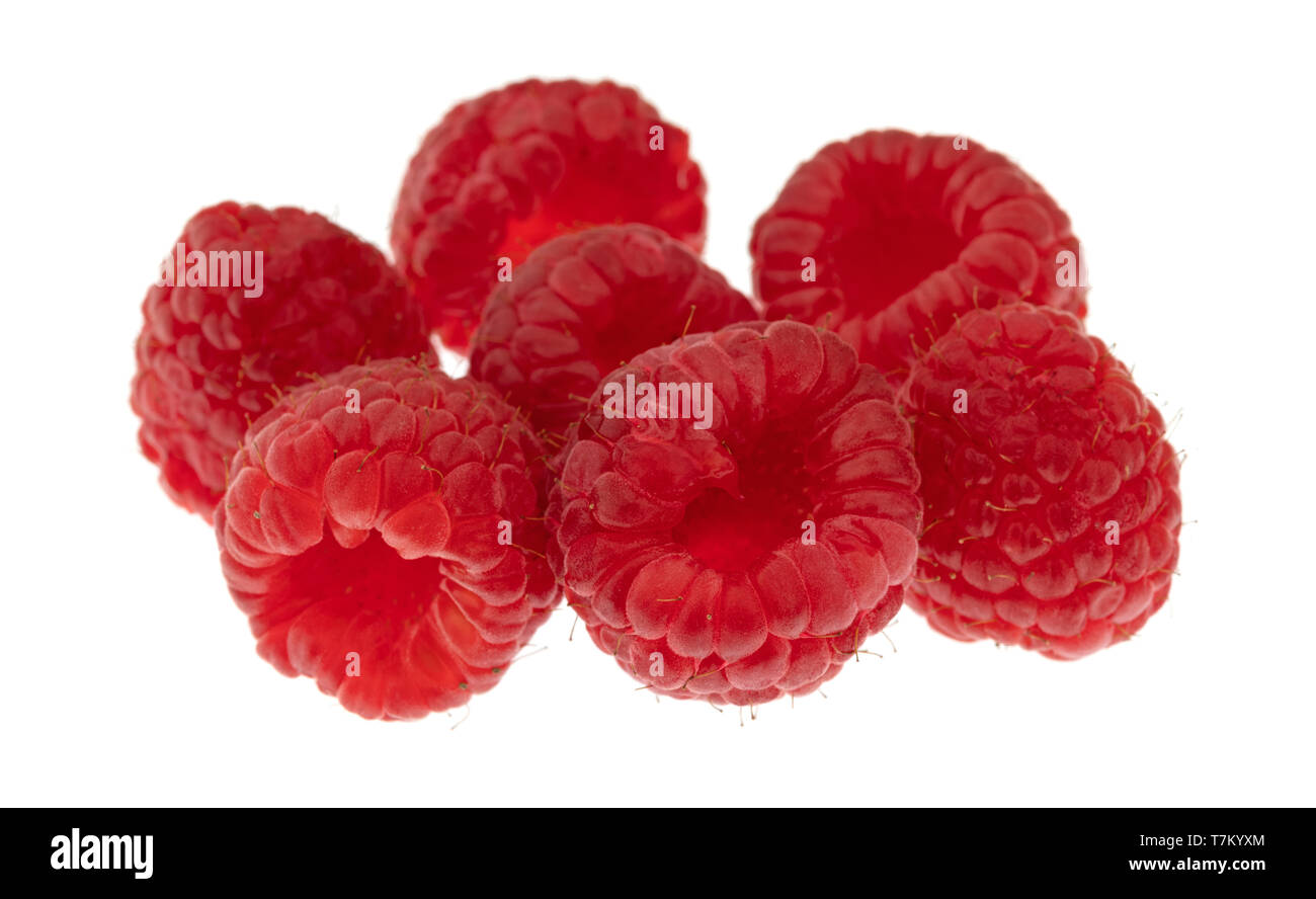 Side view of a group of freshly picked red raspberries isolated on a ...