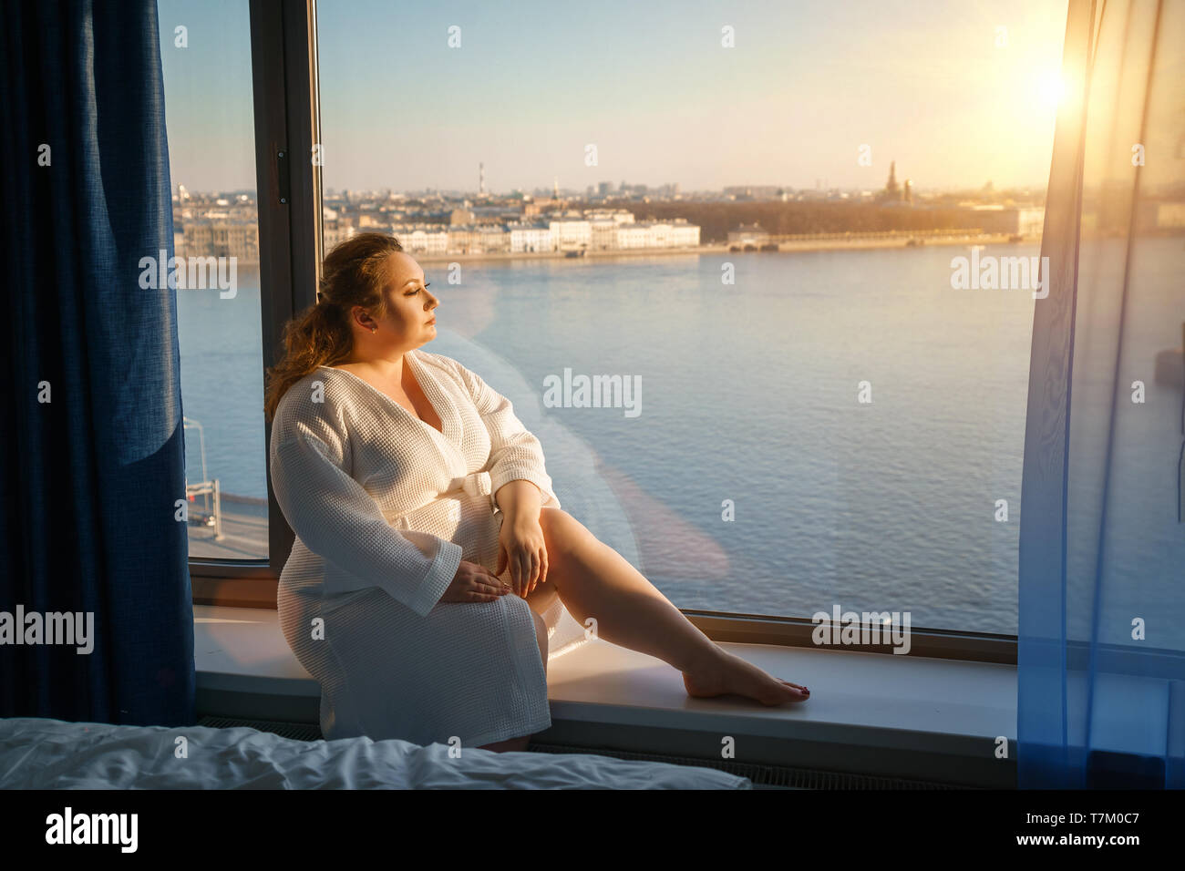 fat woman looking out the window, the concept of excess weight Stock ...