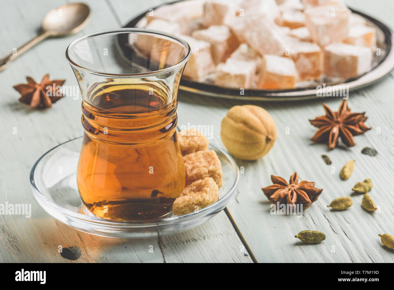 Tea in arab glass with turkish delight Rahat Lokum and different spices ...