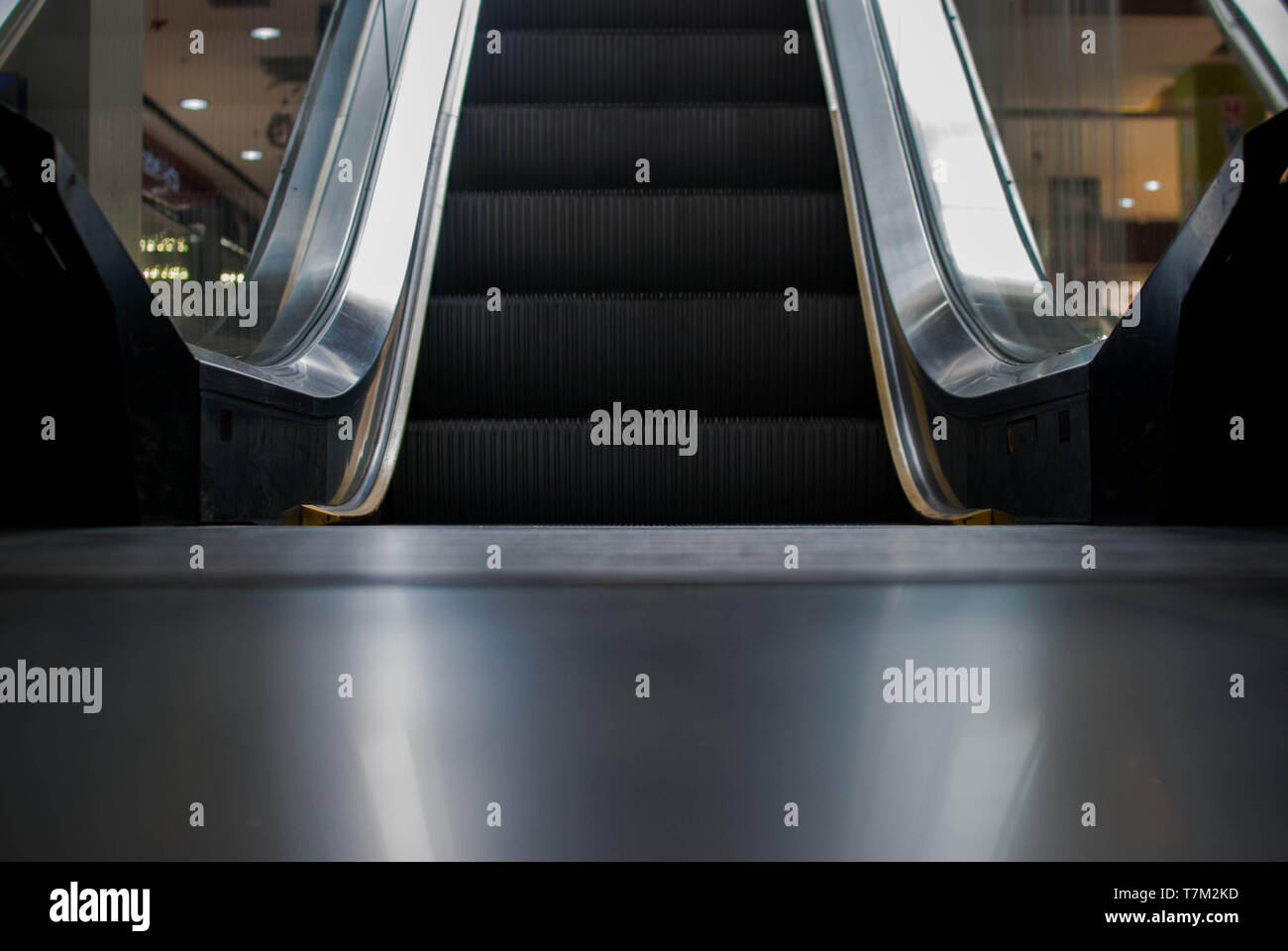 Escalator in Community Mall, Shopping Center. Moving up staircase. electric escalator. Close up ...
