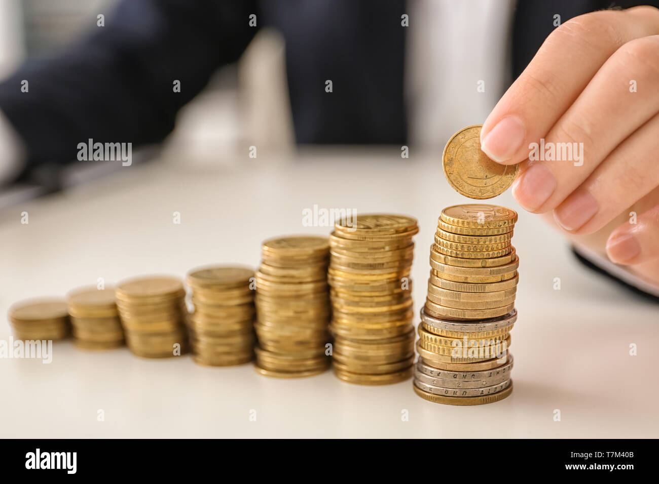 Wealth concept woman stacking hi-res stock photography and images - Alamy