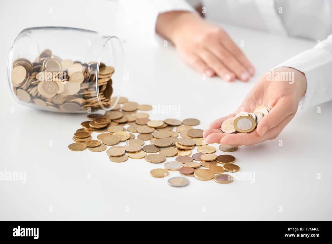 Woman counting money at table. Savings concept Stock Photo - Alamy