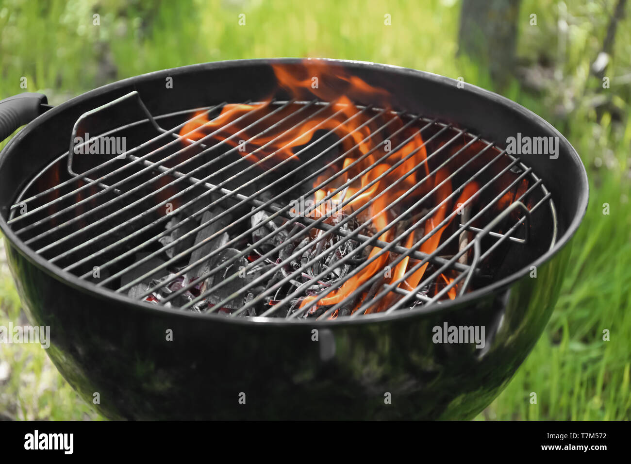 Barbecue grill with flame outdoors Stock Photo - Alamy