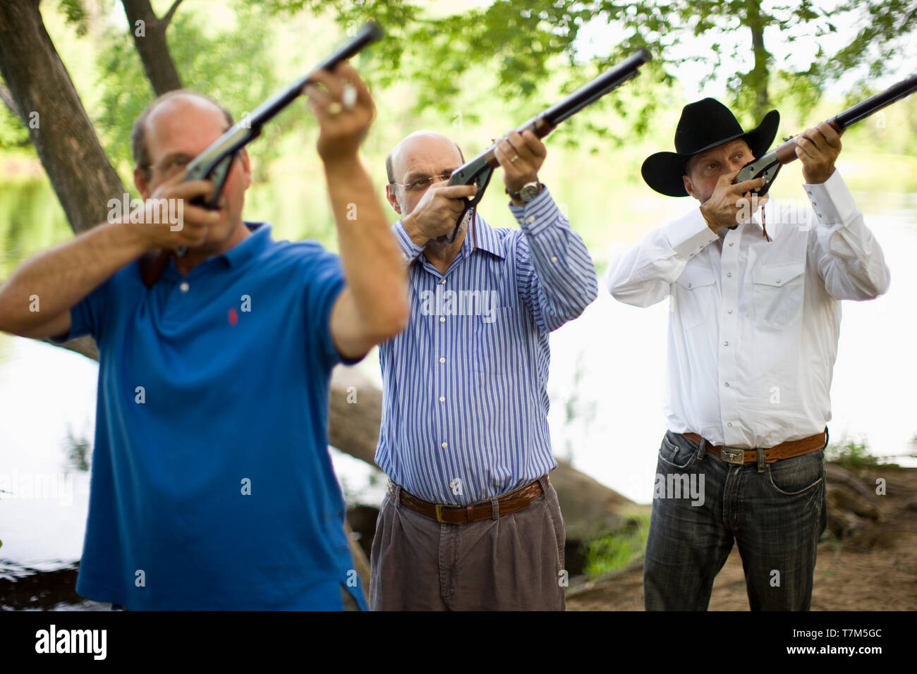 Men aiming rifles upwards Stock Photo - Alamy