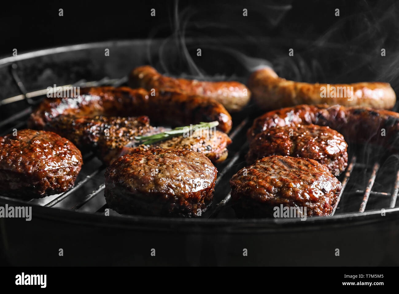 Delicious cooked patties on barbecue grill Stock Photo - Alamy