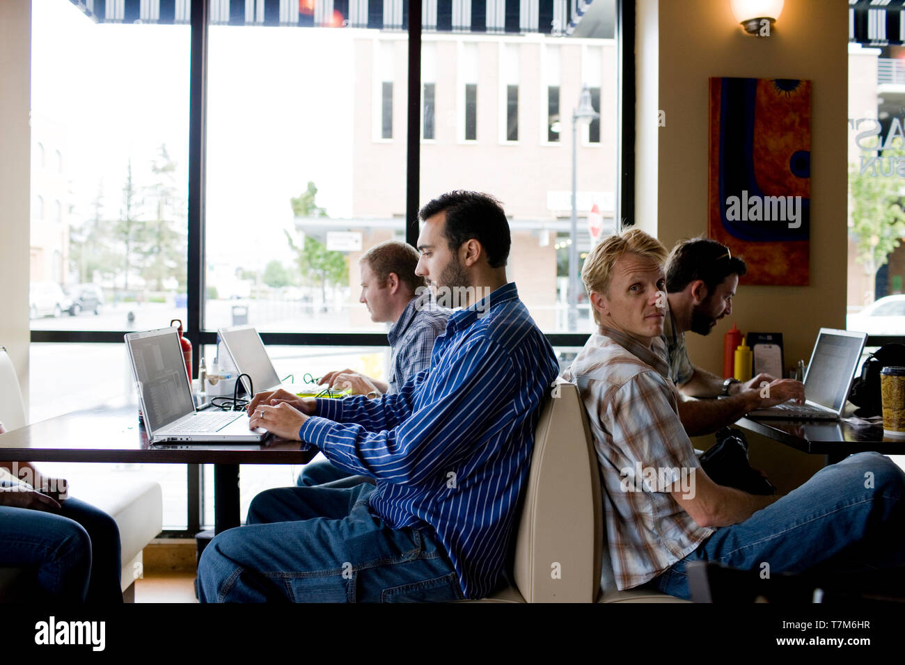 Men using laptops in internet cafe Stock Photo - Alamy