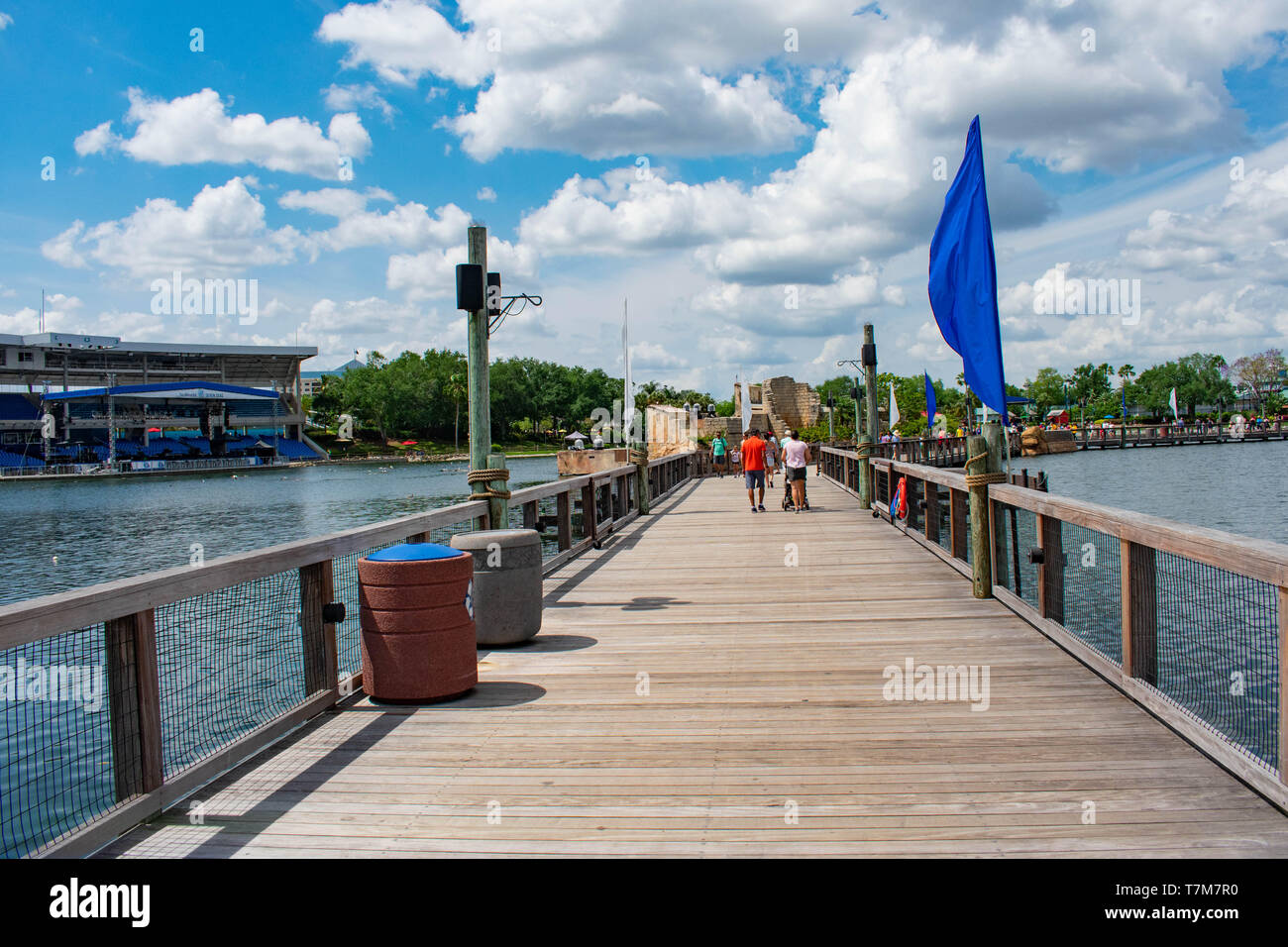 Orlando, Florida. April 7, 2019. People walking on the wood bridge on ...
