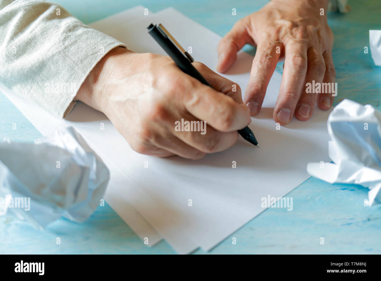 A pen in a man's hand. White sheet of paper. Signing a document Stock ...
