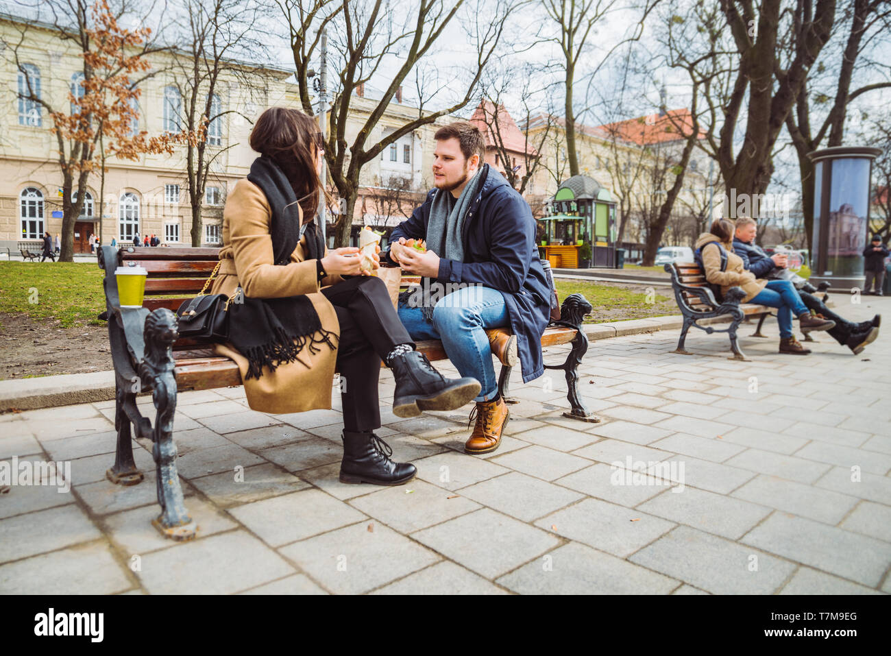 Woman eating burger bench hi-res stock photography and images - Alamy