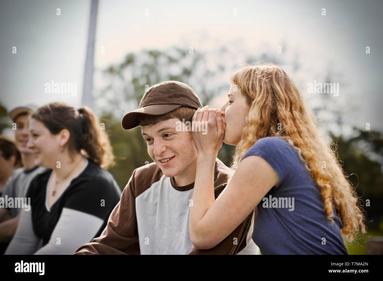Girl whispering in boy's ear hi-res stock photography and images - Alamy