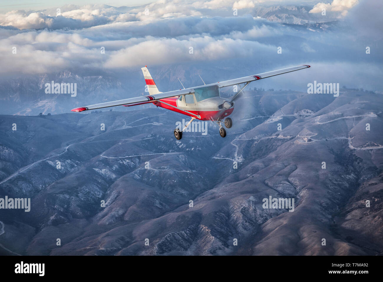Small single engine airplane flying in the gorgeous sunset sky through ...