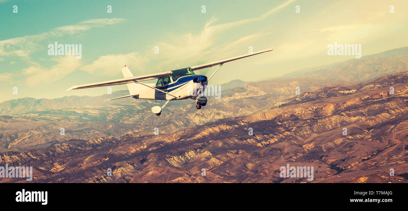 Small single engine airplane flying in the gorgeous sunset sky through ...