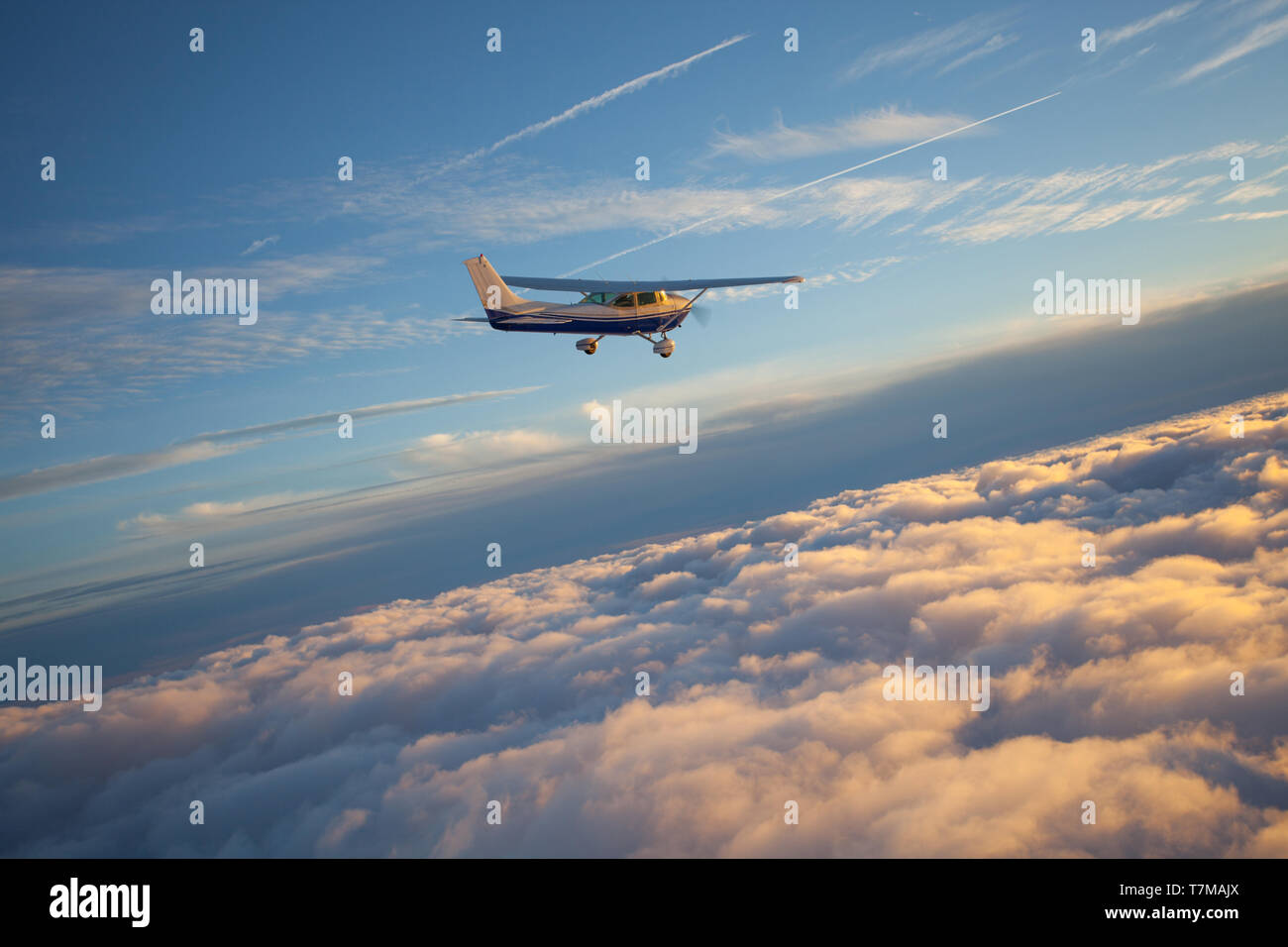 Small single engine airplane flying in the gorgeous sunset sky through ...