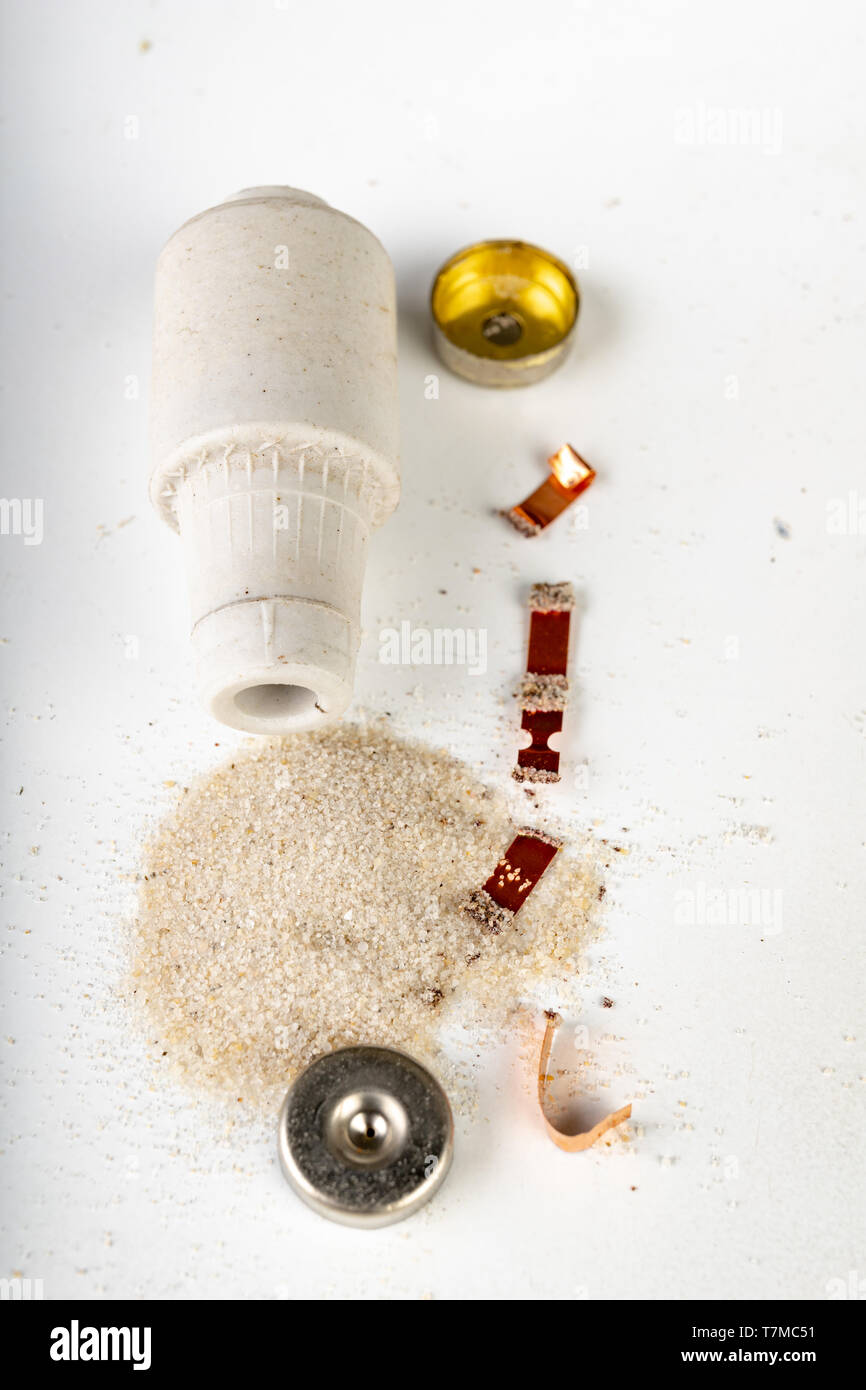 Old ceramic electric fuse. Blown and badly repaired security for energy ...