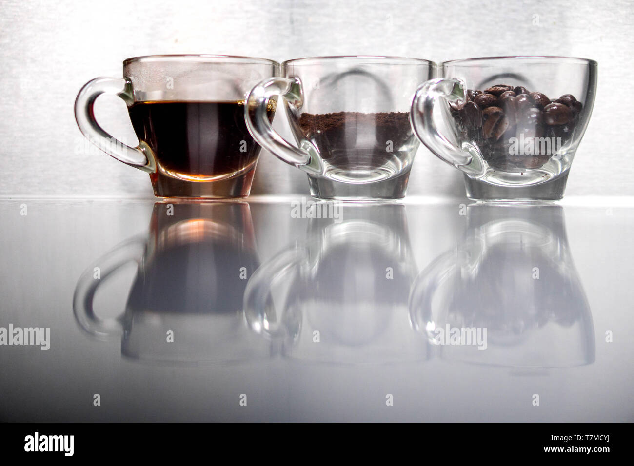 Three cups of coffee reflection Stock Photo - Alamy