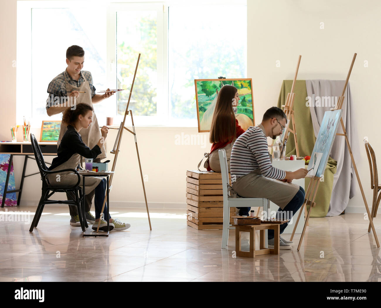 Group of people during classes in school of painters Stock Photo - Alamy