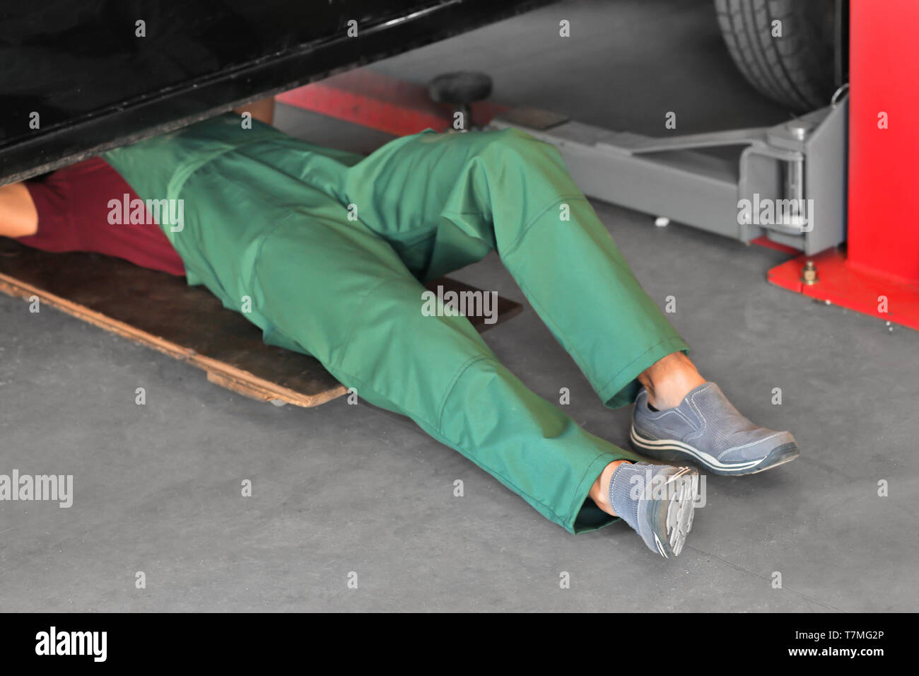 Mechanic under car legs hi-res stock photography and images - Alamy