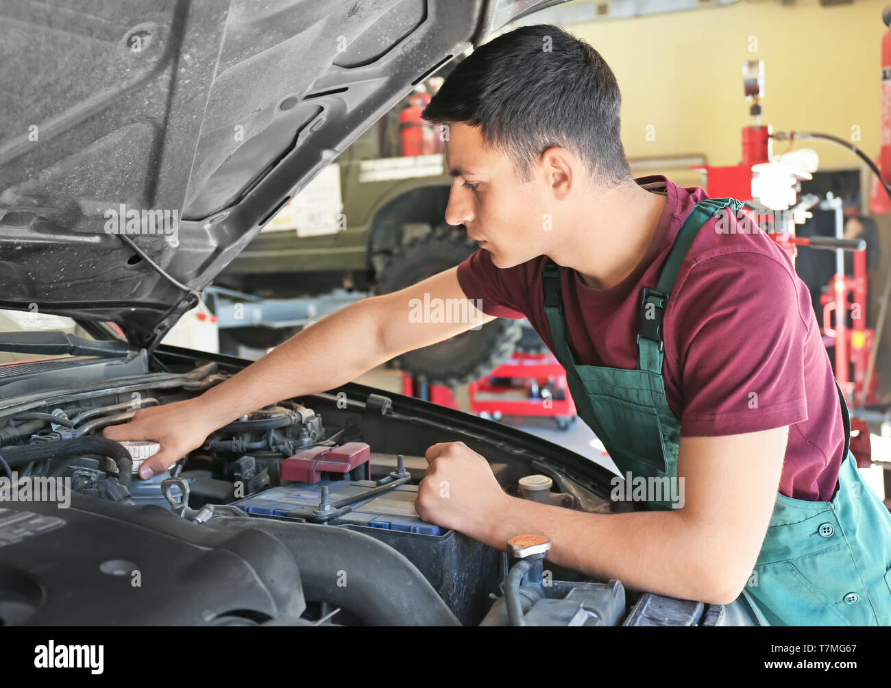 Young auto mechanic repairing car in service center Stock Photo - Alamy
